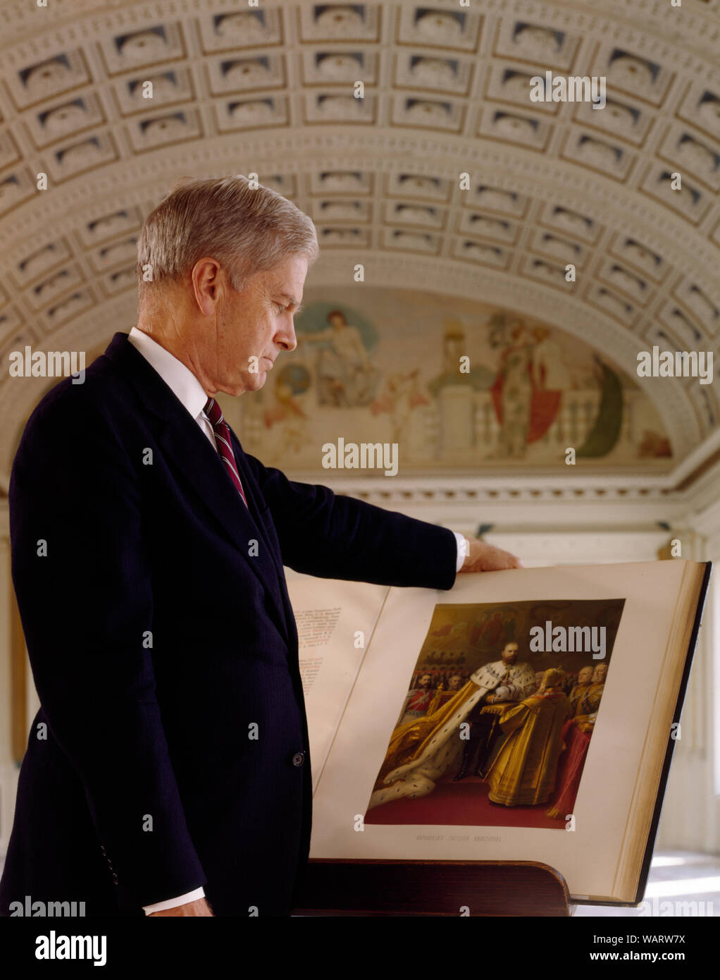 Dr. James Billington, Librarian of Congress, looking at one of the rare ...