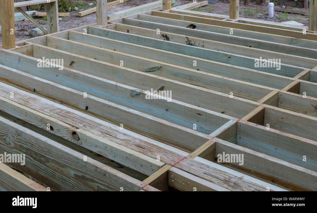 A new wooden, timber deck being constructed. it is on the decking. New ...