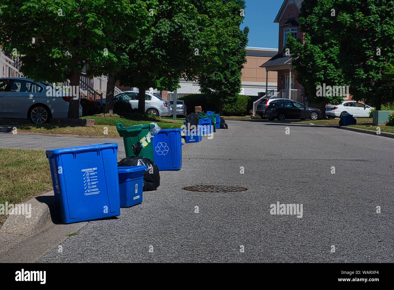 Garbage, recycling and food waste bins are waiting to be picked up in ...