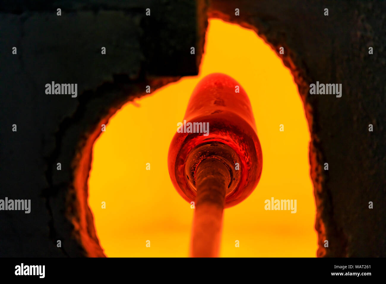 Glass blower manufacturing process, working on a bubble of melted glass ...
