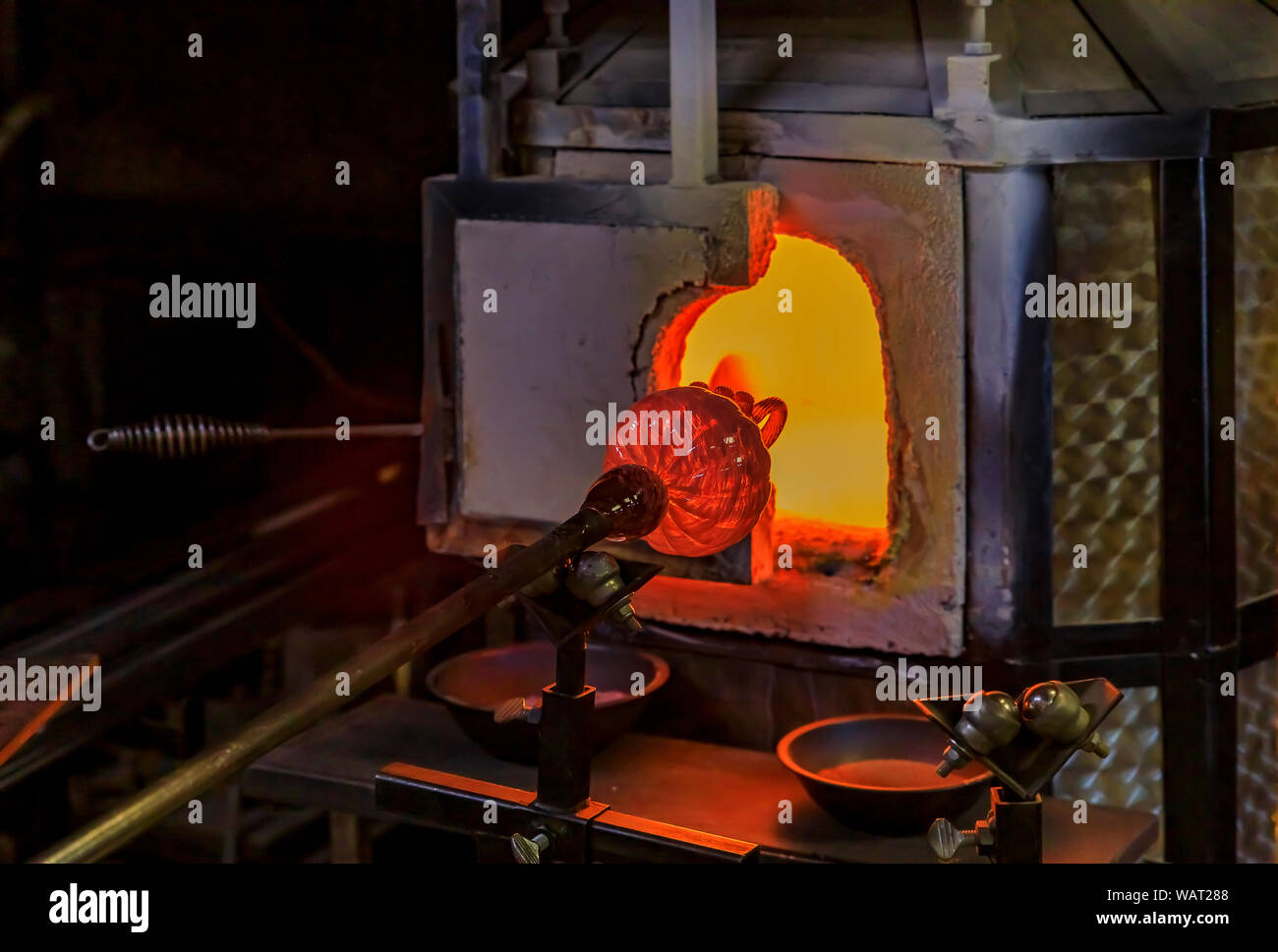 Glass blower manufacturing process, working on a bubble of melted glass ...