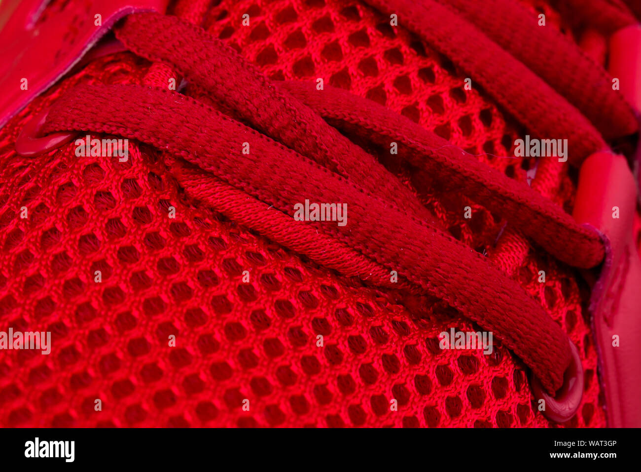 A fragment of a red sneaker close up. Sneaker texture Stock Photo - Alamy