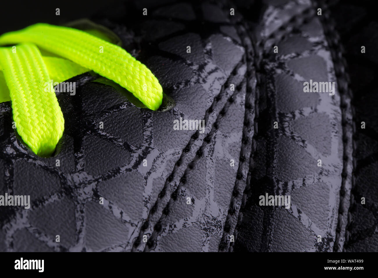 Fragment of black sneaker with green laces close up. Sneaker texture ...