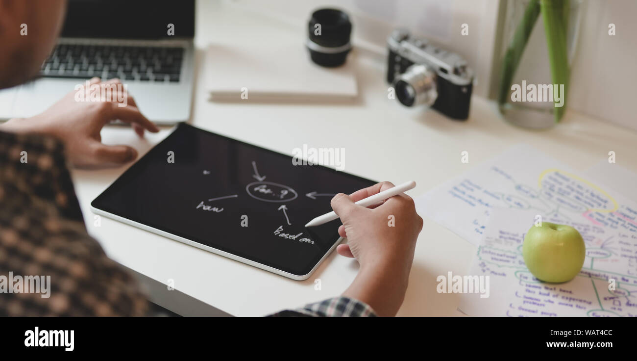 Close-up of young designer drawing mind mapping about his project on ...