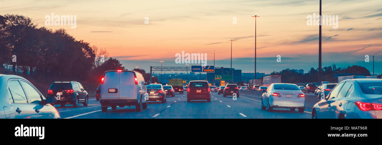 Night traffic. Cars on highway road at sunset evening in busy american ...