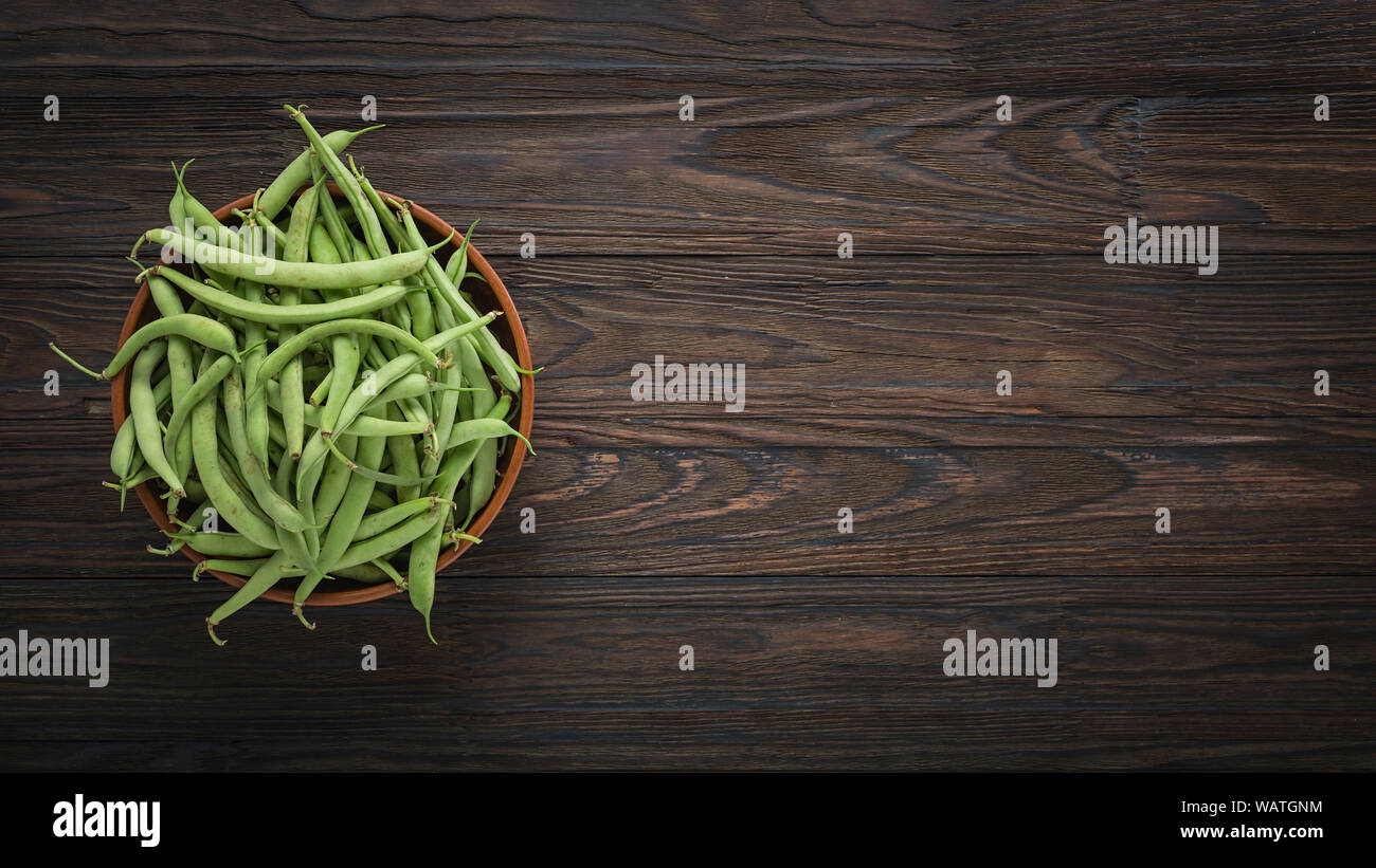 String beans in a wooden bowl. Vegetarian food. A source of vitamins ...