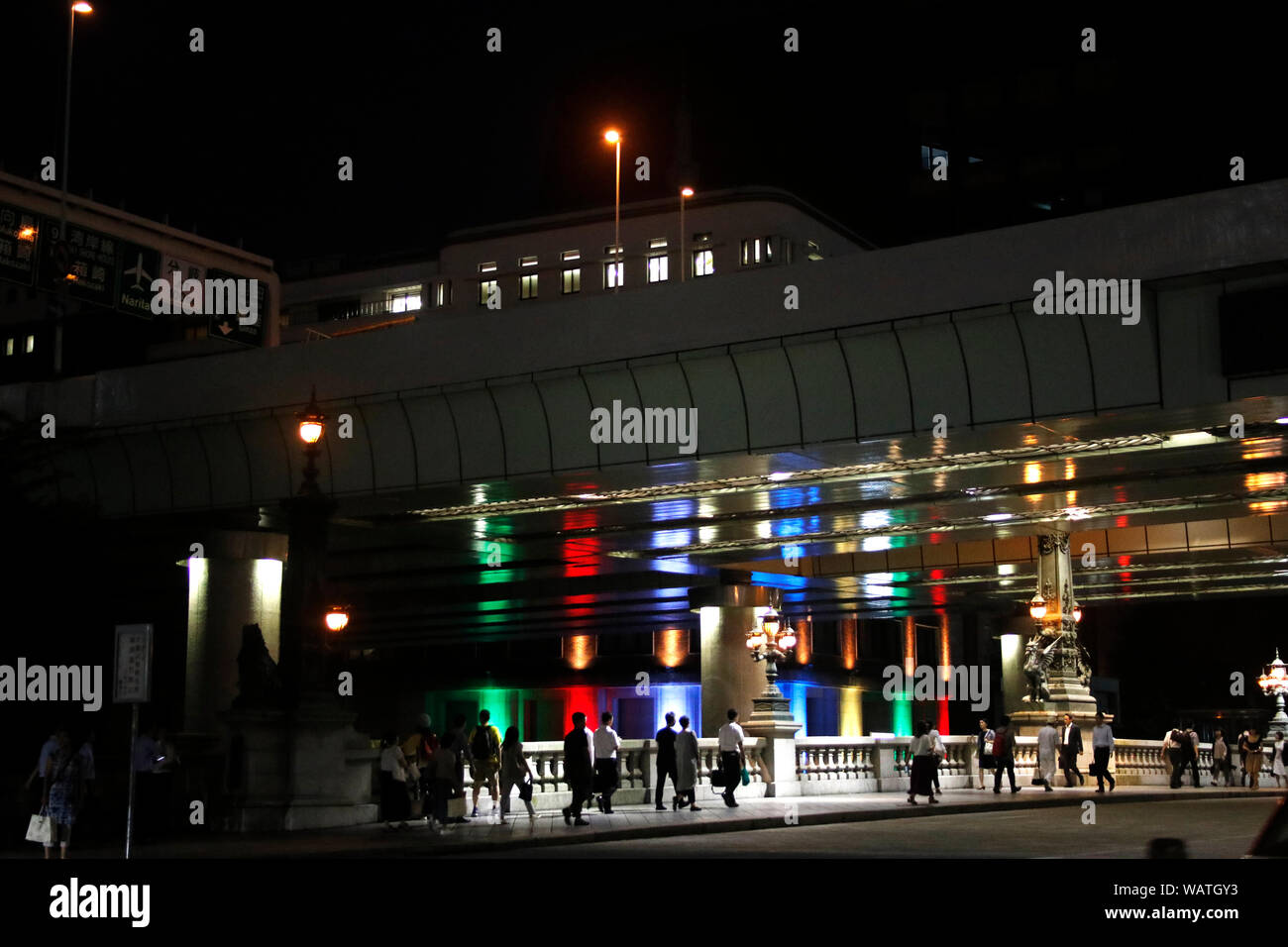The building is illuminated with colors of the Olympic rings to mark ...