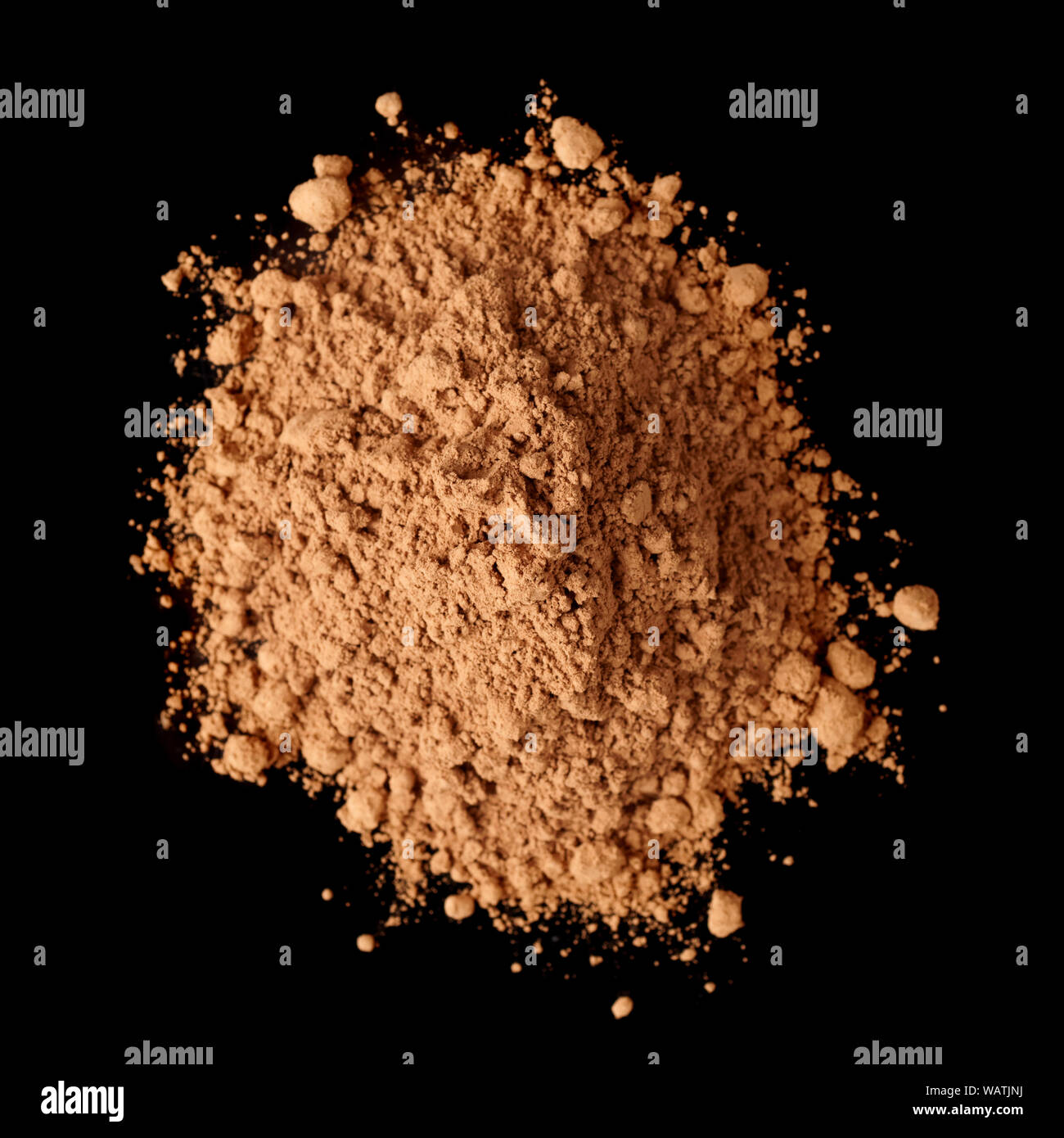 Pile of cocoa powder isolated on black background, shot from above ...