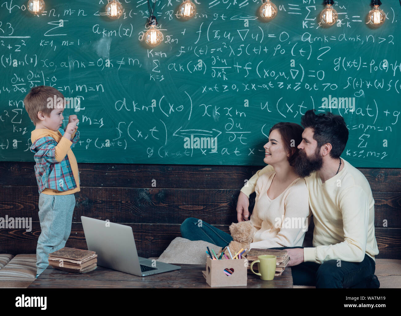Parents listening their son, classroom, laptop, chalkboard on ...