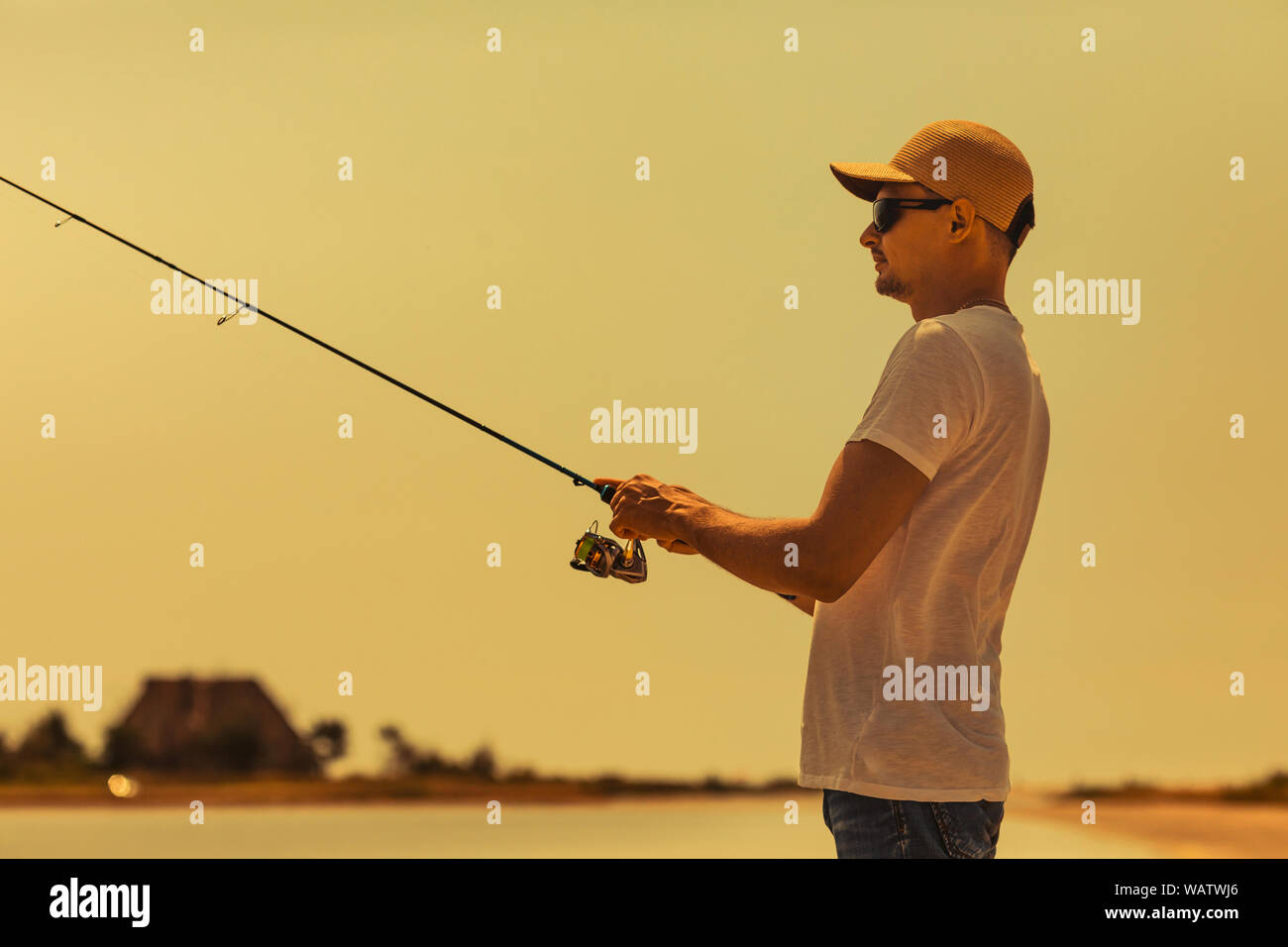 Fisherman uses spinning reel catch hi-res stock photography and images ...