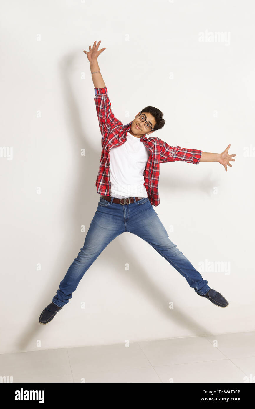 College student jumping in mid air Stock Photo - Alamy