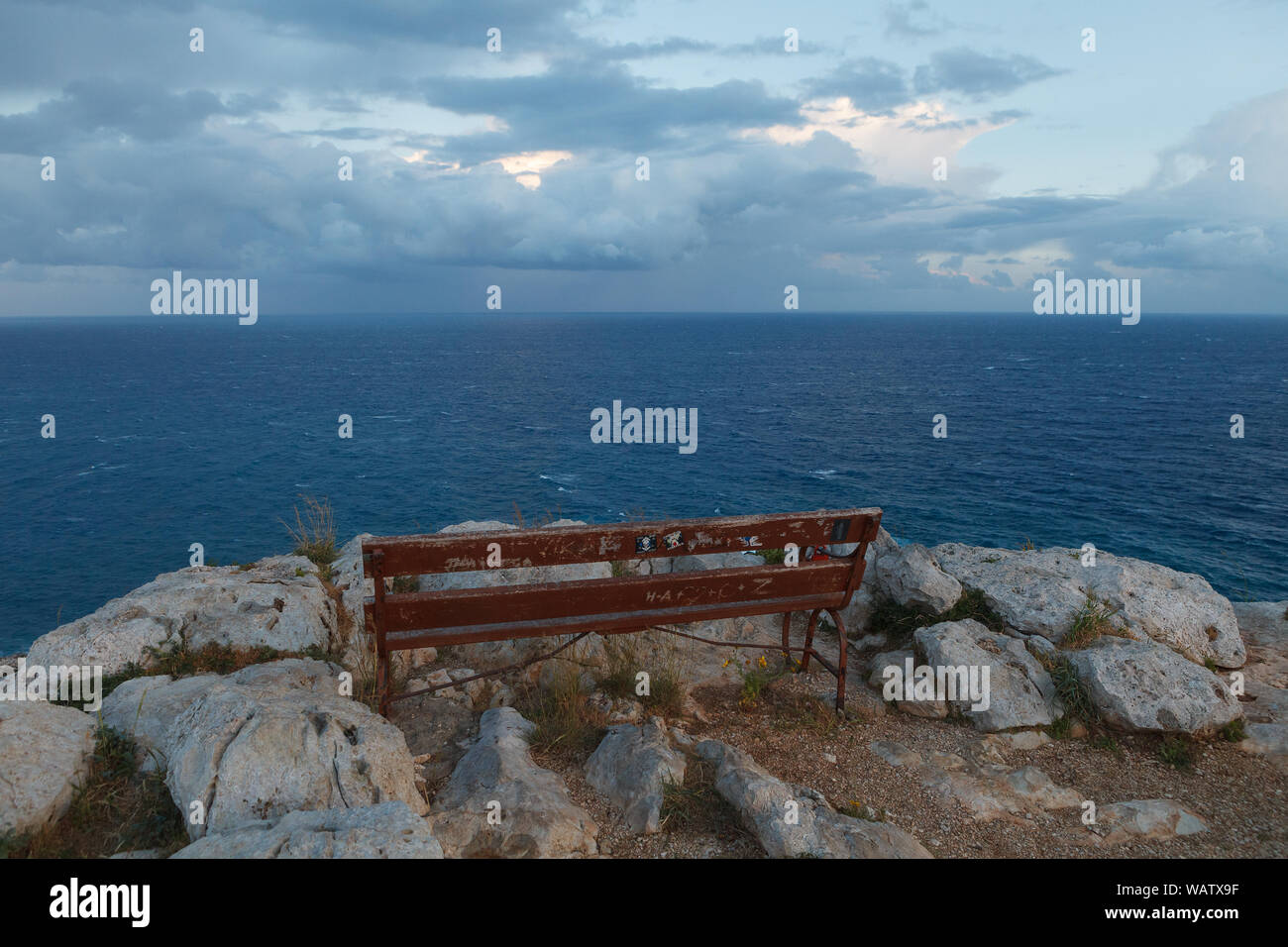 An empty bench for relaxing on the background of the sea and mountains ...