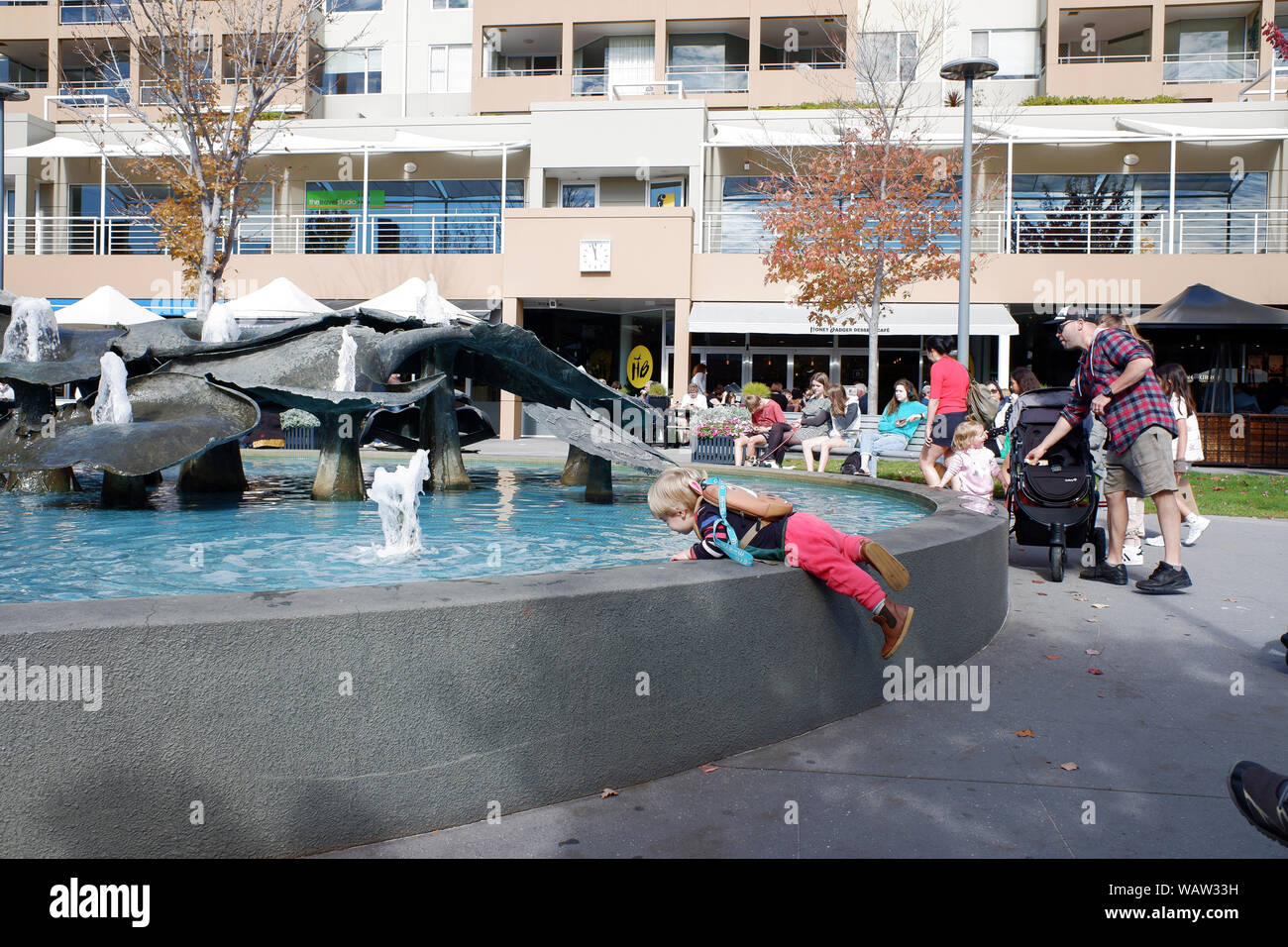 CHILDREN PLAYING NEAR WATER FEATURE Stock Photo - Alamy