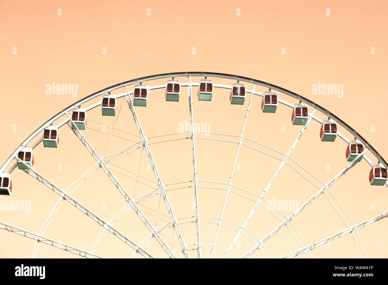 Detail of a ferris wheel on pastel peach background Stock Photo - Alamy
