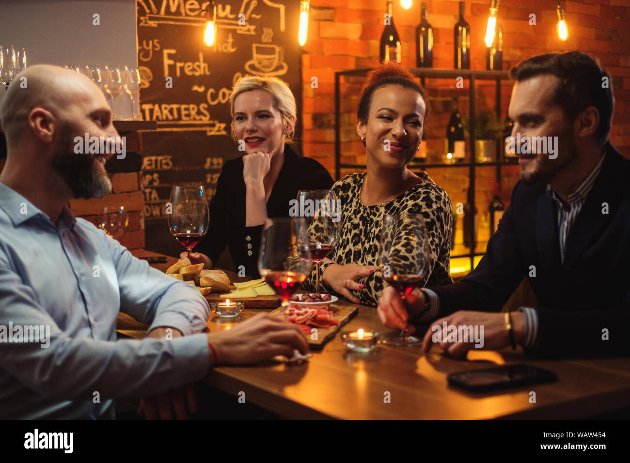 Group of friends having fun talk behind bar counter in a cafe Stock ...