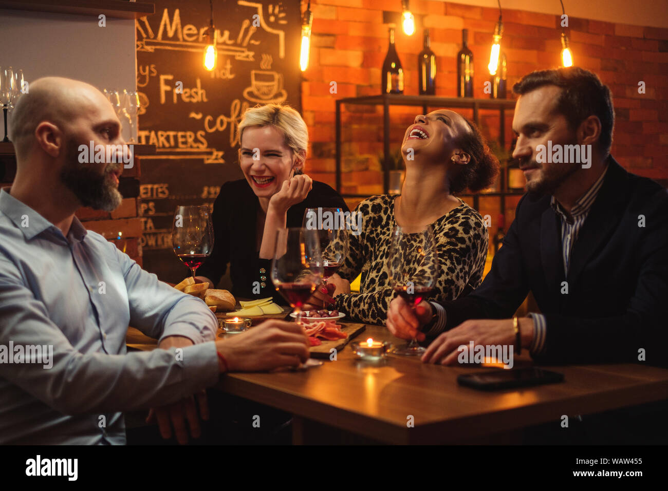 Group of friends having fun talk behind bar counter in a cafe Stock ...