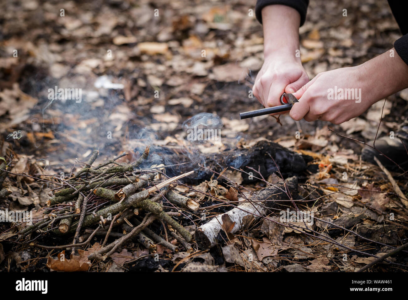 A man makes a fire with a flint Stock Photo - Alamy