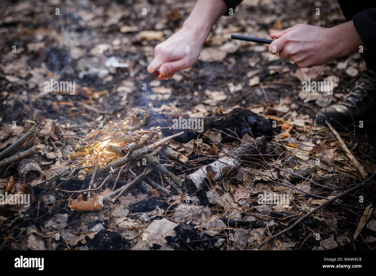 A man makes a fire with a flint Stock Photo - Alamy