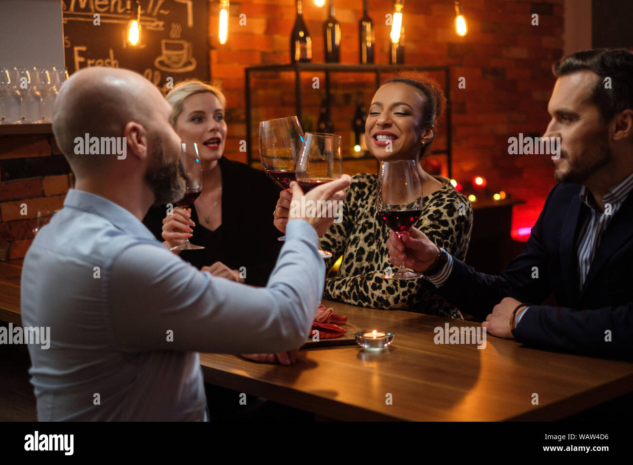 Group of friends having fun talk behind bar counter in a cafe Stock ...