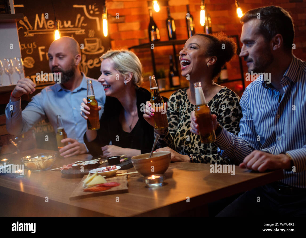 Group of friends having fun talk behind bar counter in a cafe Stock ...