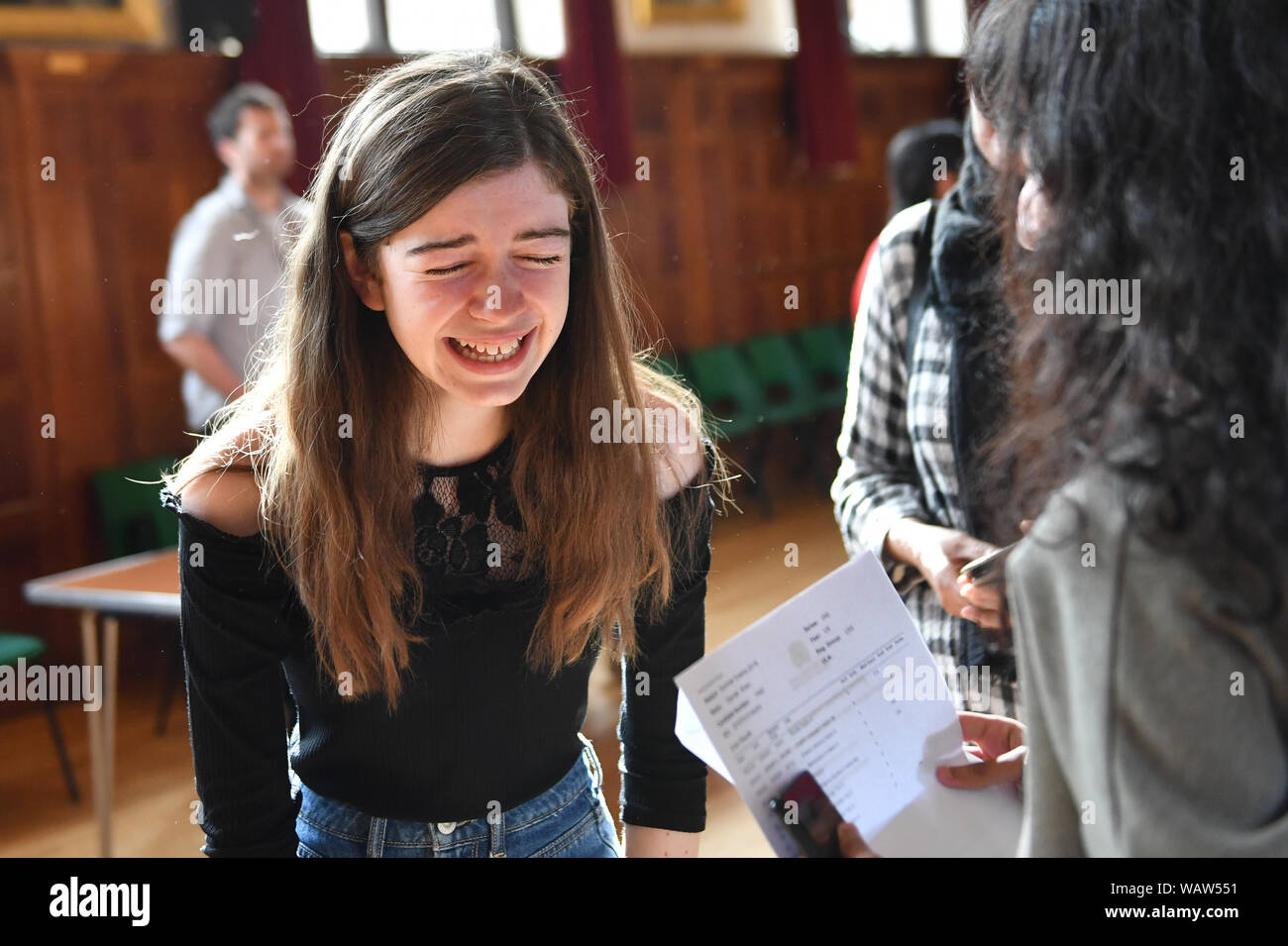 Emily Fox (left), who got all grade 9s, hugs a friend as pupils get ...