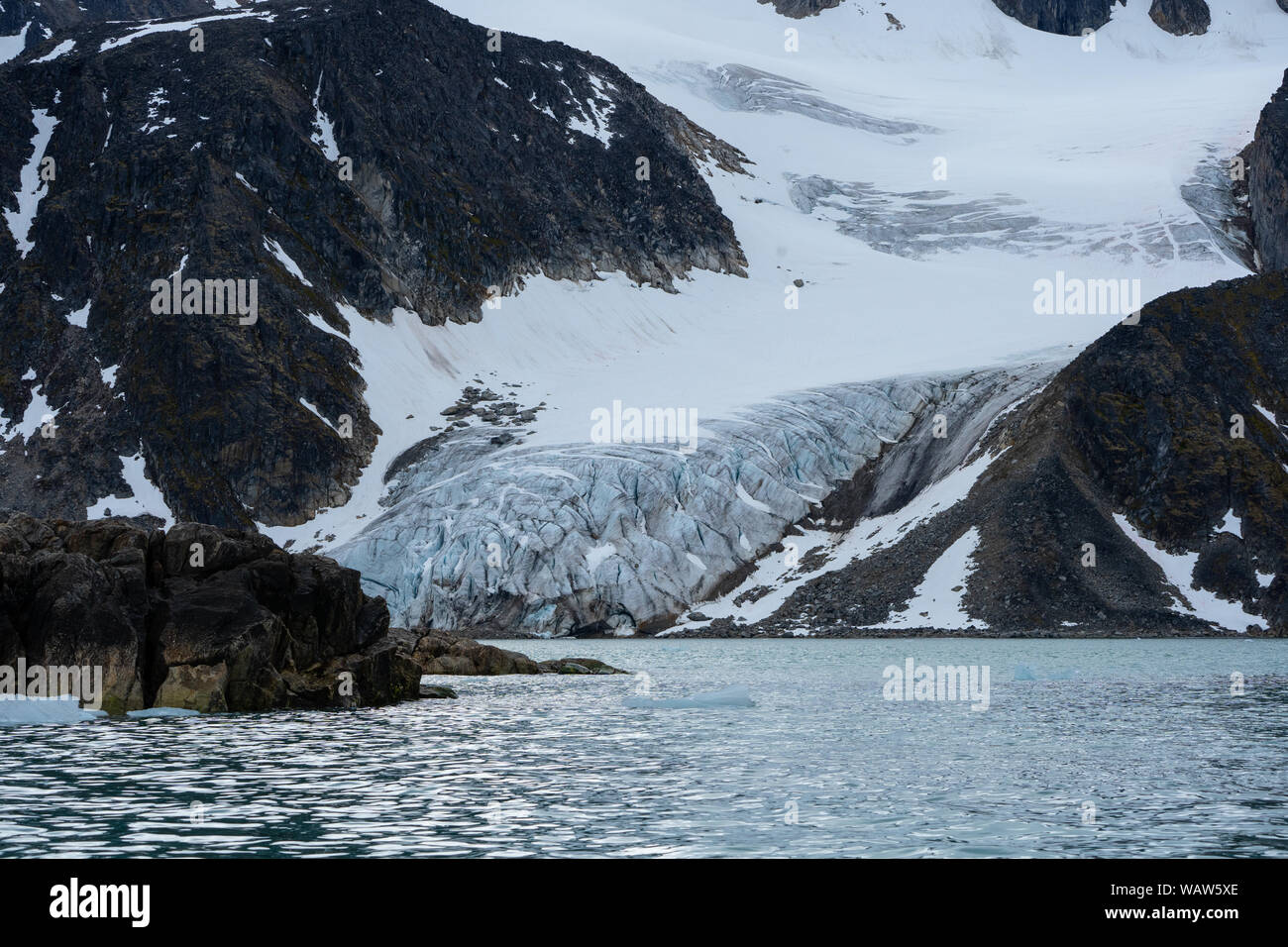 Glacier alongside rocks in the North Sea of Norway Stock Photo - Alamy