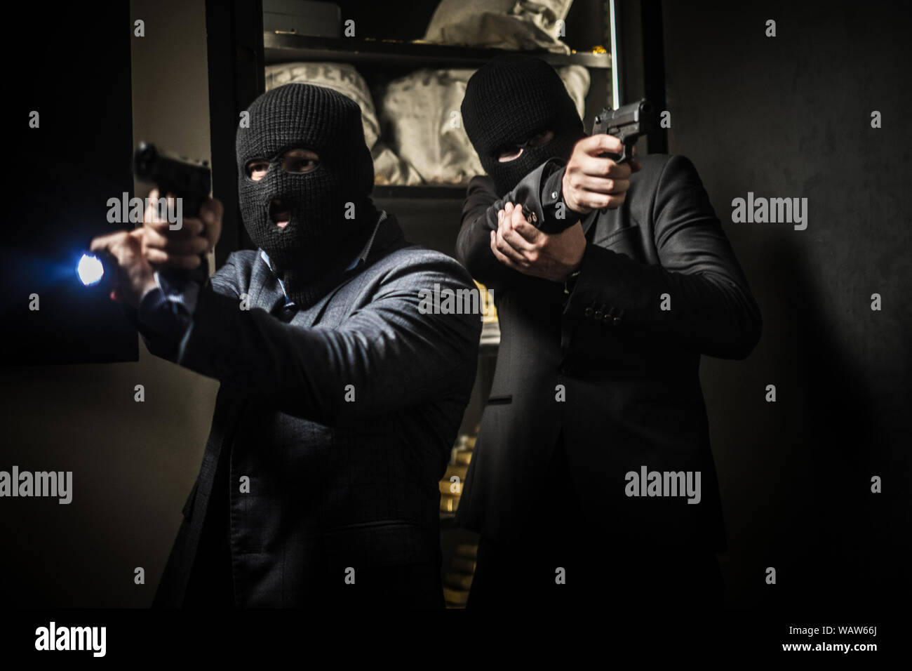 Two ardmed men robbing a bank Stock Photo - Alamy
