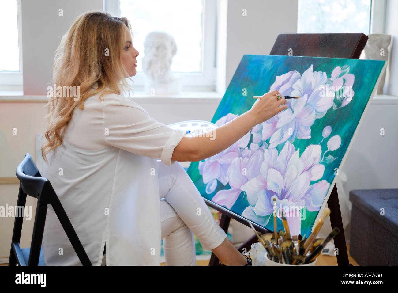 Creative painter paints a colorful picture in her studio Stock Photo ...