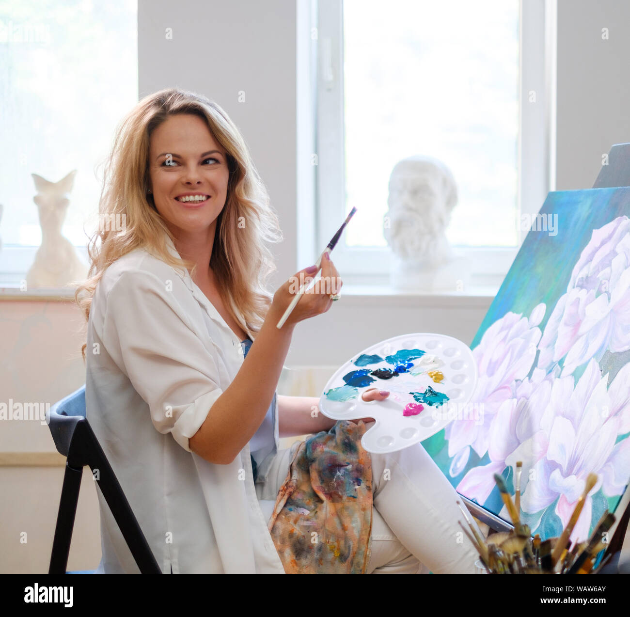 Creative painter paints a colorful picture in her studio Stock Photo ...