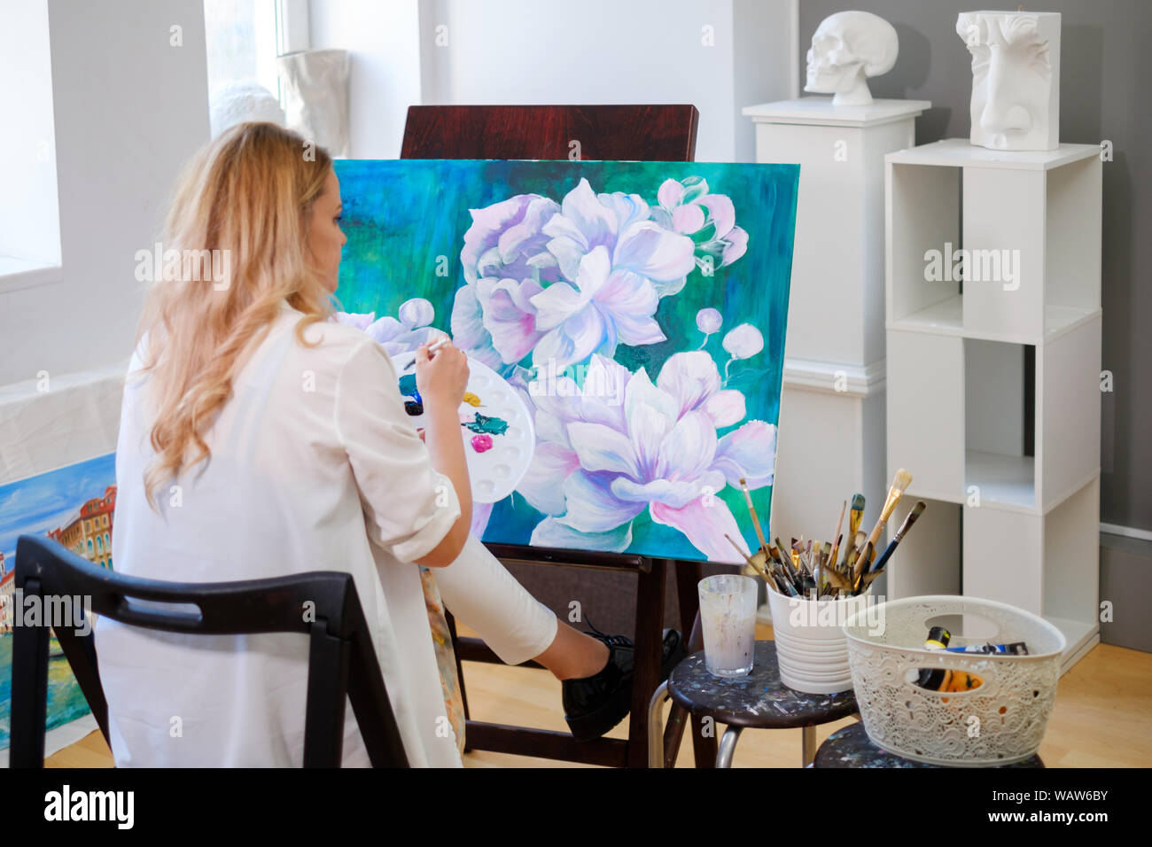 Creative painter paints a colorful picture in her studio Stock Photo ...