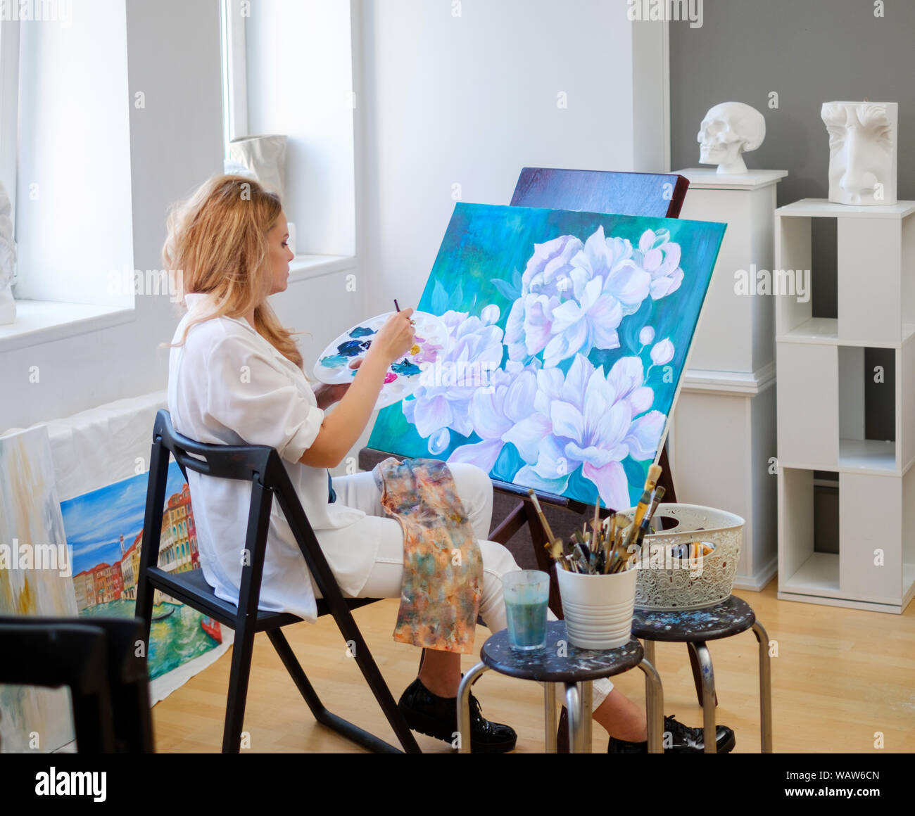 Creative painter paints a colorful picture in her studio Stock Photo ...