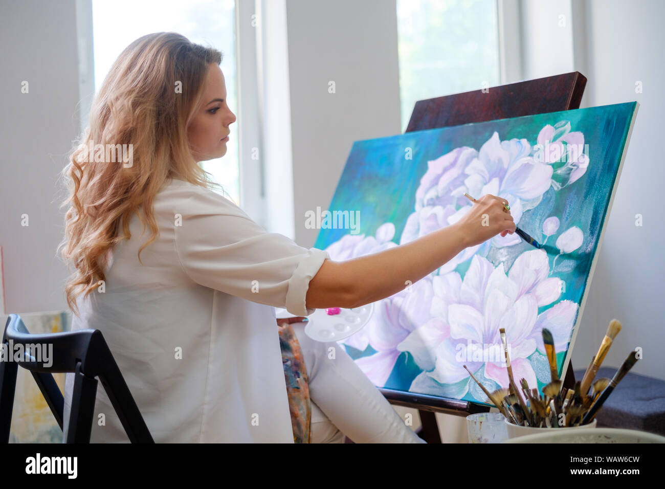 Creative painter paints a colorful picture in her studio Stock Photo ...
