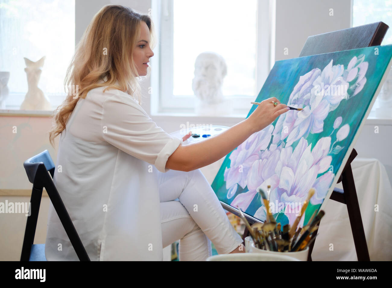 Creative painter paints a colorful picture in her studio Stock Photo ...