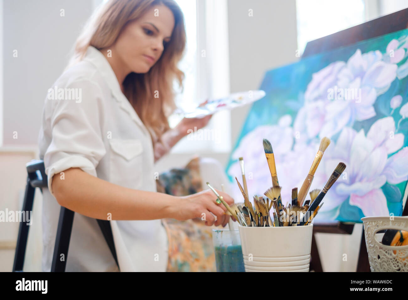 Creative painter paints a colorful picture in her studio Stock Photo ...