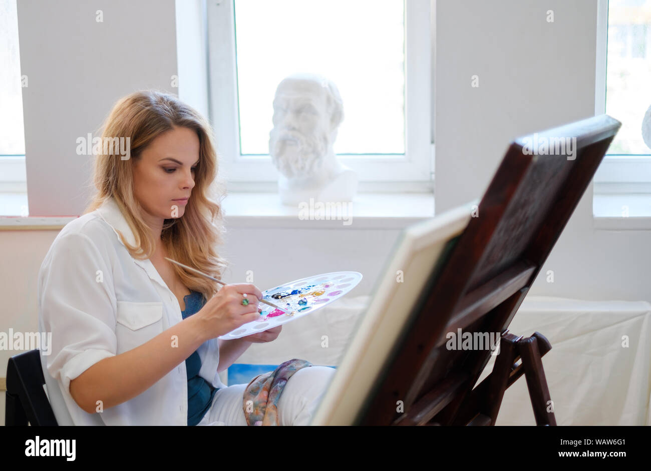 Creative painter paints a colorful picture in her studio Stock Photo ...