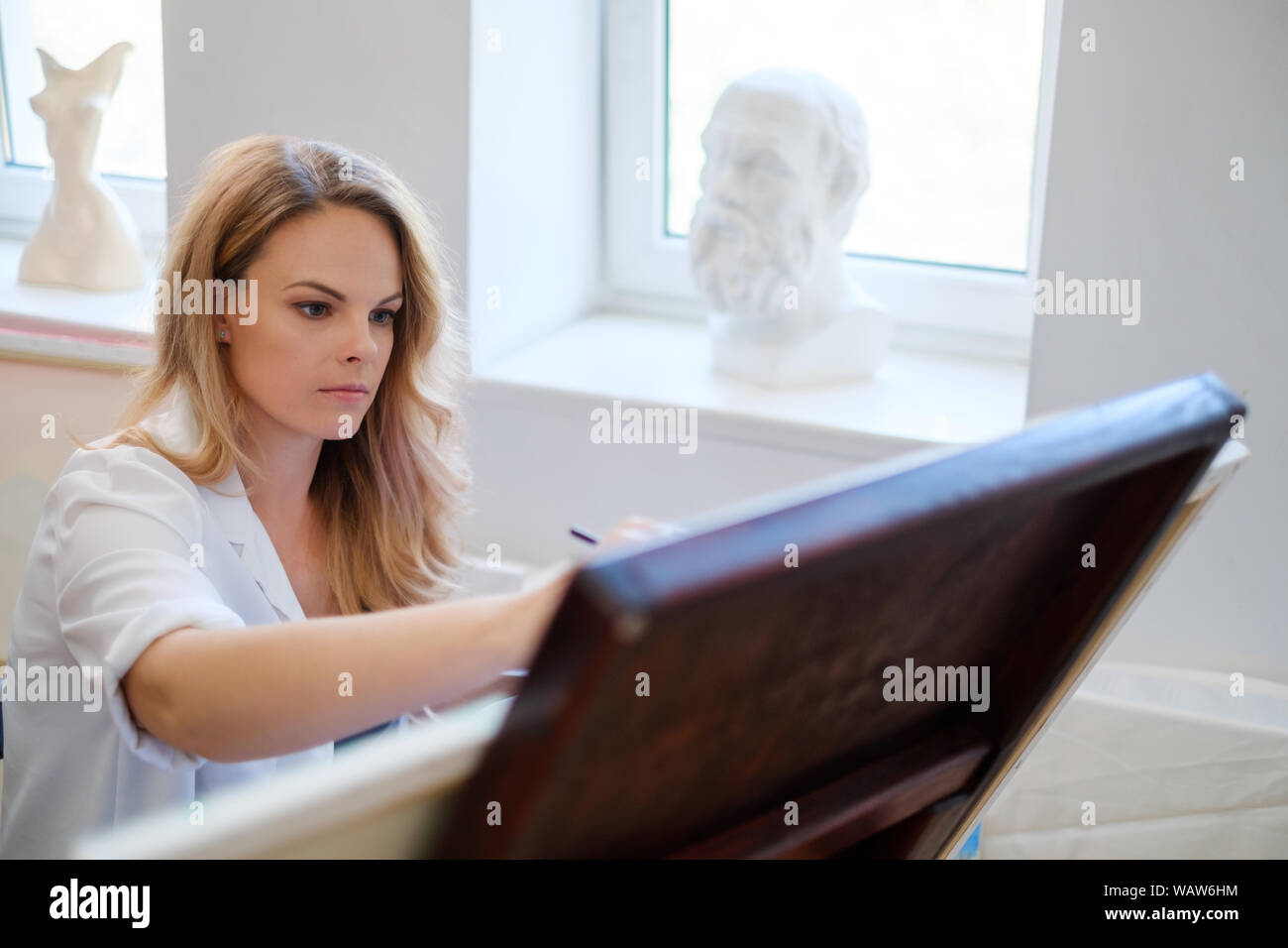 Creative painter paints a colorful picture in her studio Stock Photo ...