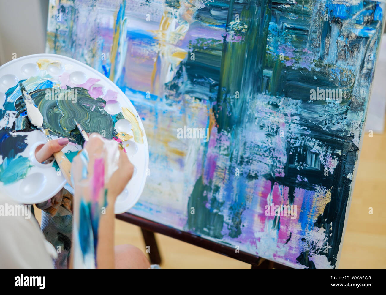 Creative painter paints a colorful picture in her studio Stock Photo ...