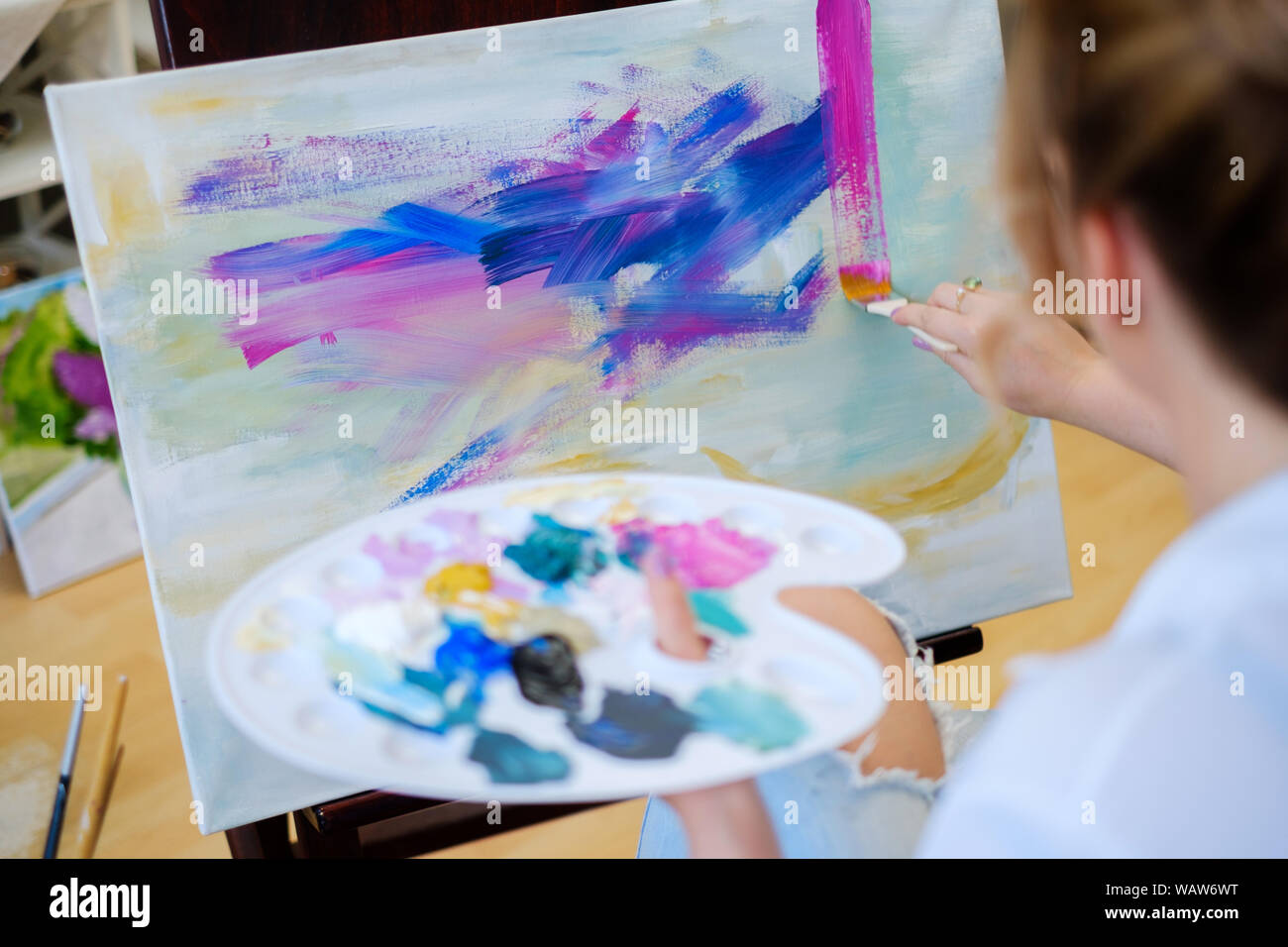 Creative painter paints a colorful picture in her studio Stock Photo ...