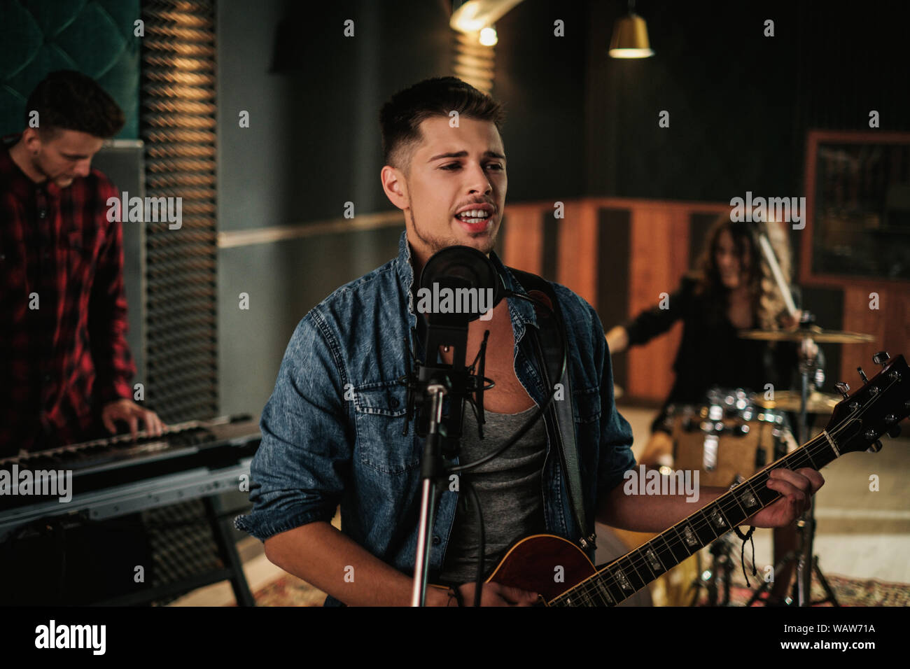 Music band having rehearsal in a studio Stock Photo - Alamy