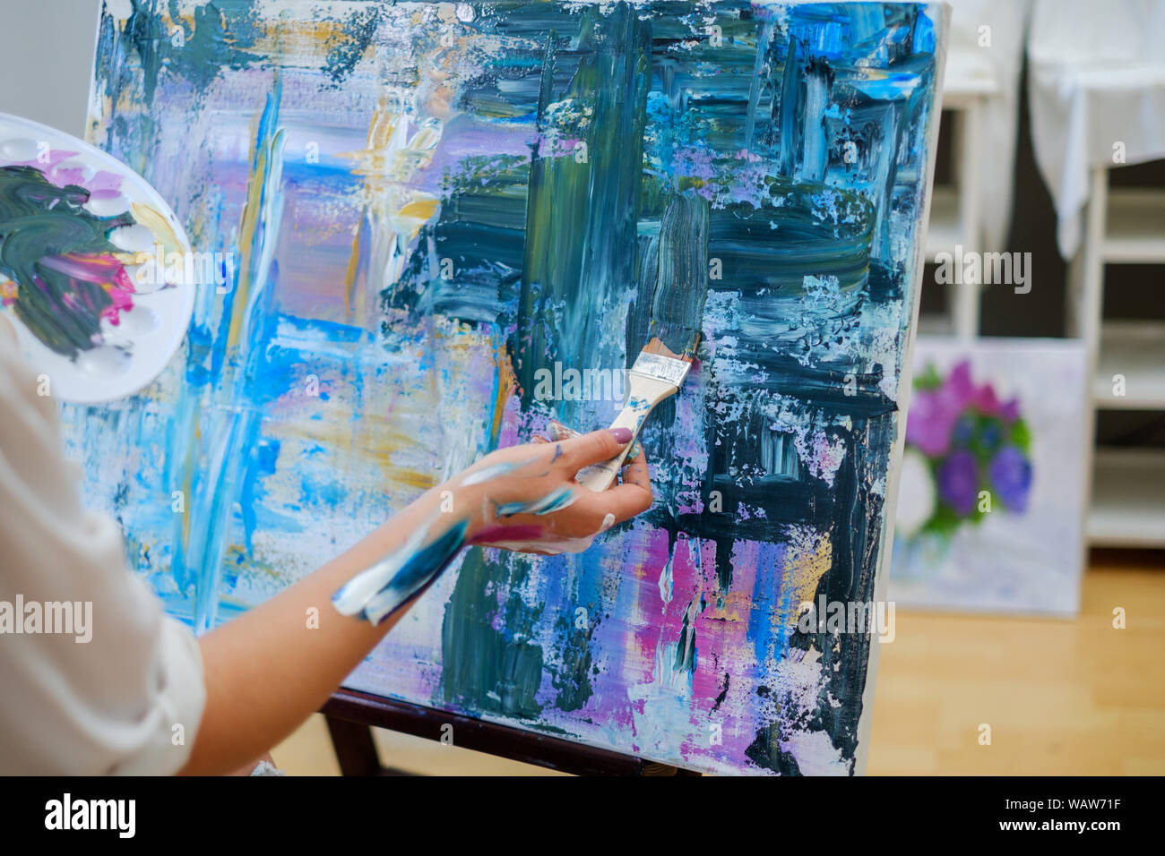 Creative painter paints a colorful picture in her studio Stock Photo ...