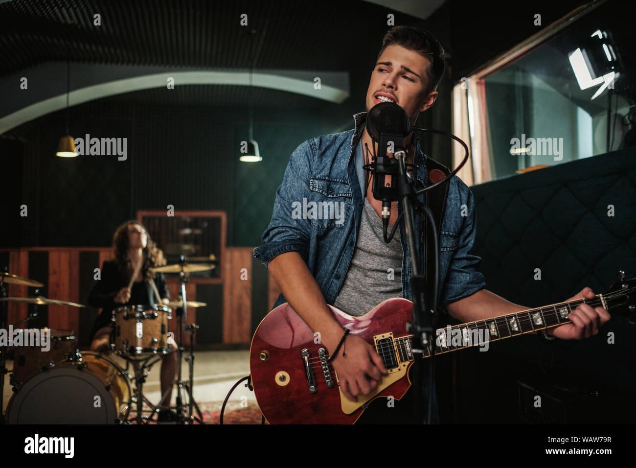Music band having rehearsal in a studio Stock Photo - Alamy