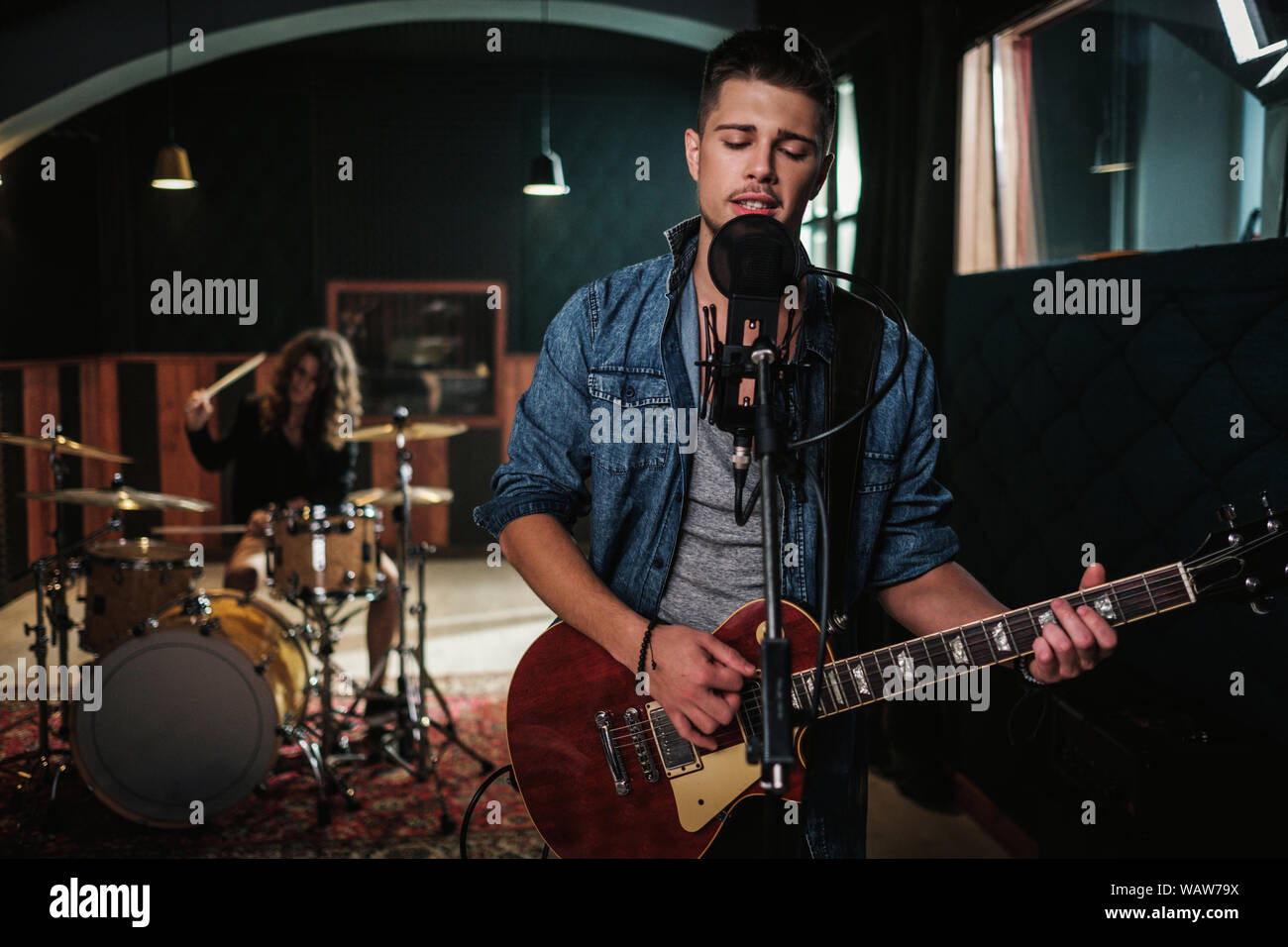 Music band having rehearsal in a studio Stock Photo - Alamy