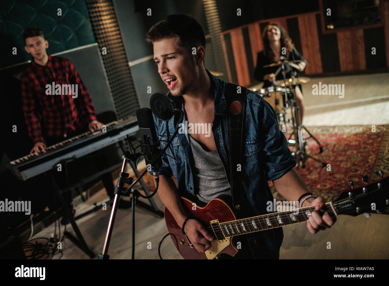 Music band having rehearsal in a studio Stock Photo - Alamy