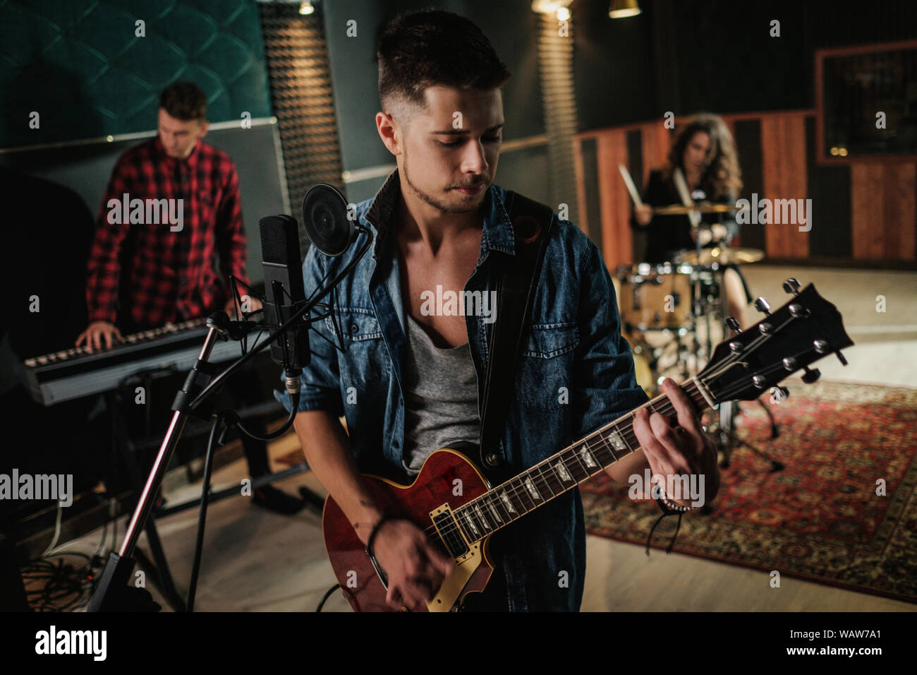Music band having rehearsal in a studio Stock Photo - Alamy