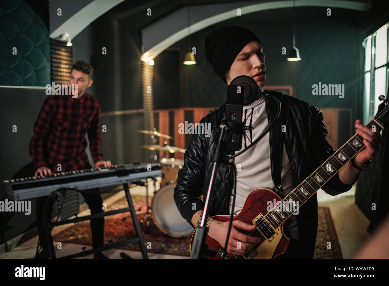 Music band having rehearsal in a studio Stock Photo - Alamy