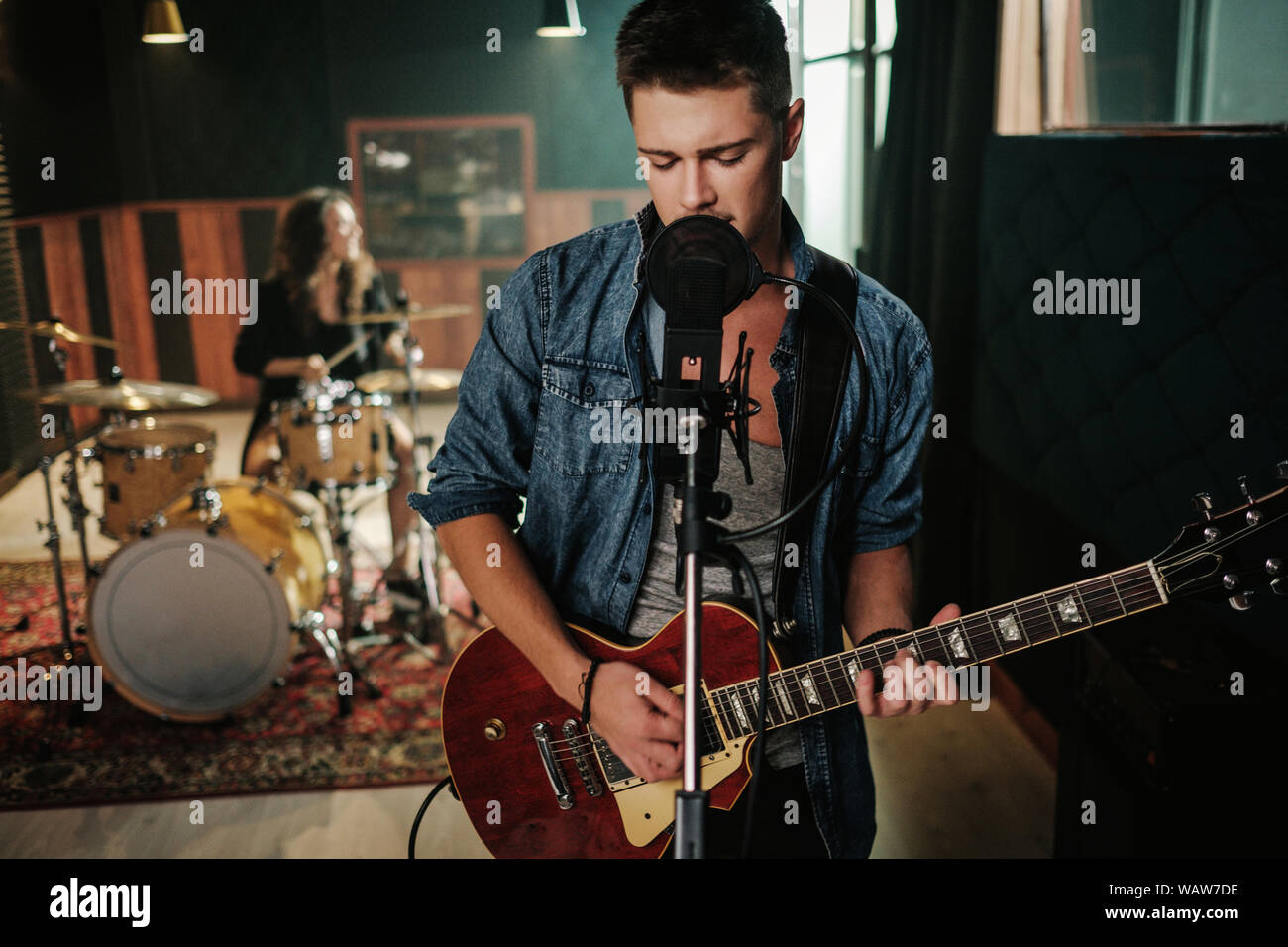 Music band having rehearsal in a studio Stock Photo - Alamy