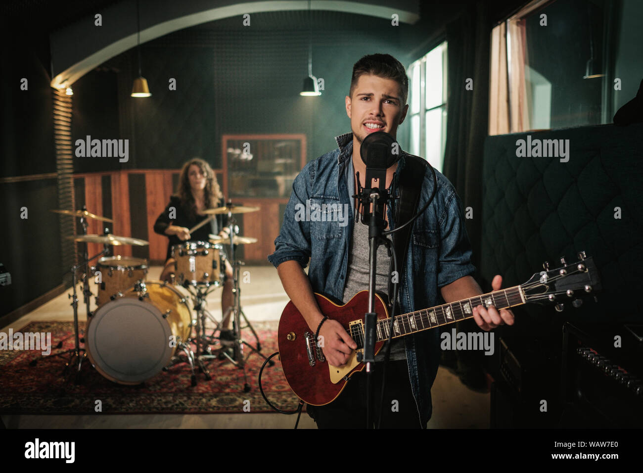 Music band having rehearsal in a studio Stock Photo - Alamy