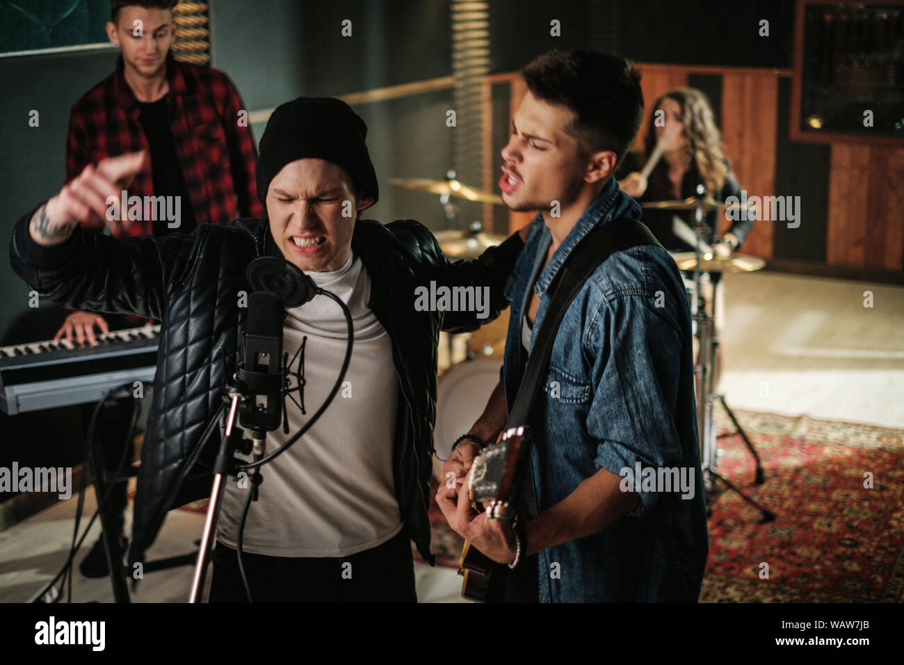 Music band having rehearsal in a studio Stock Photo - Alamy