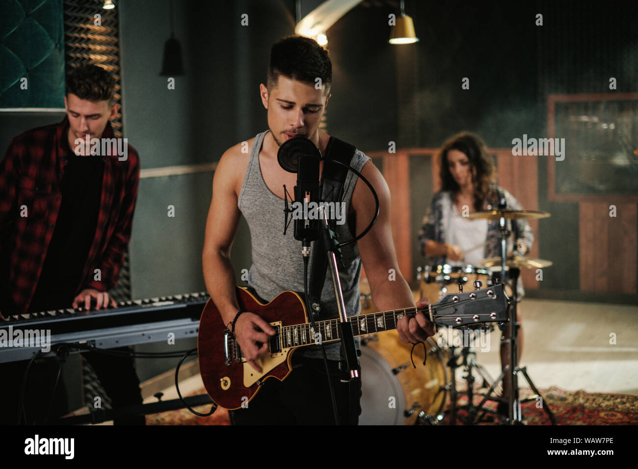Music band having rehearsal in a studio Stock Photo - Alamy