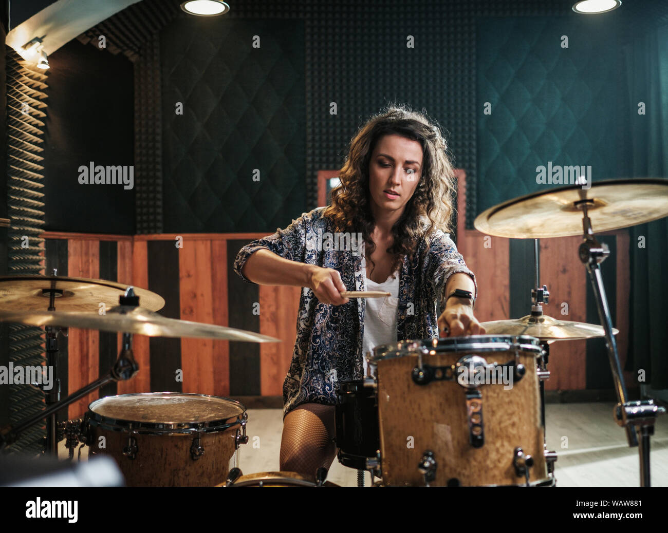 Woman playing drums during music band rehearsal Stock Photo - Alamy